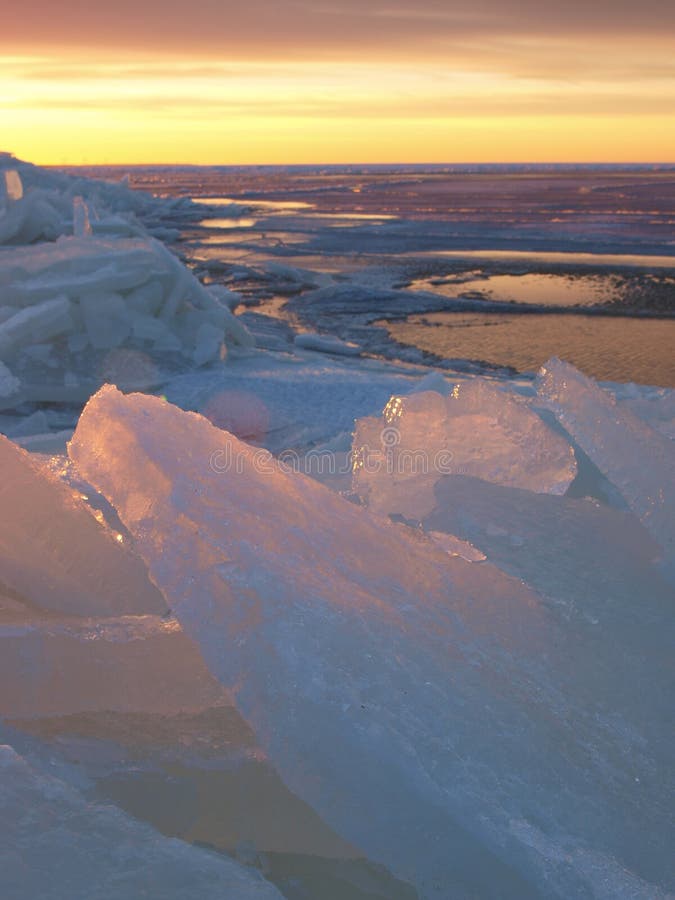 Pieces of ice at sunset stock photo. Image of winter - 18970420