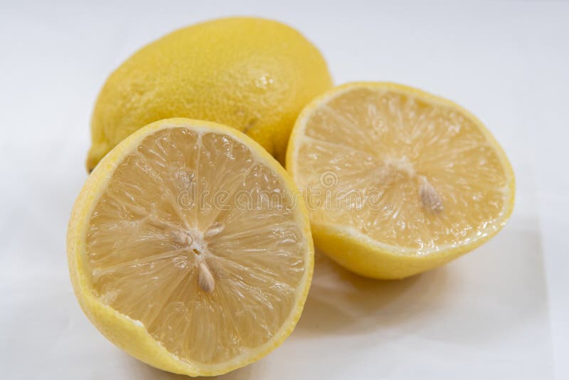 Pieces of Lemon Cut in Half and One Normal Lemon Stock Photo - Image of ...