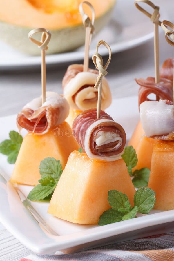 Pieces of Melon with Ham on Skewers Close Up. Vertical Stock Image ...