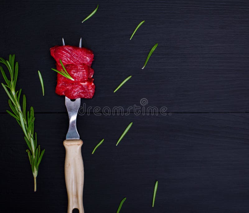 Pieces of Raw Beef on Kitchen Fork with Plastic Handle Stock Image ...
