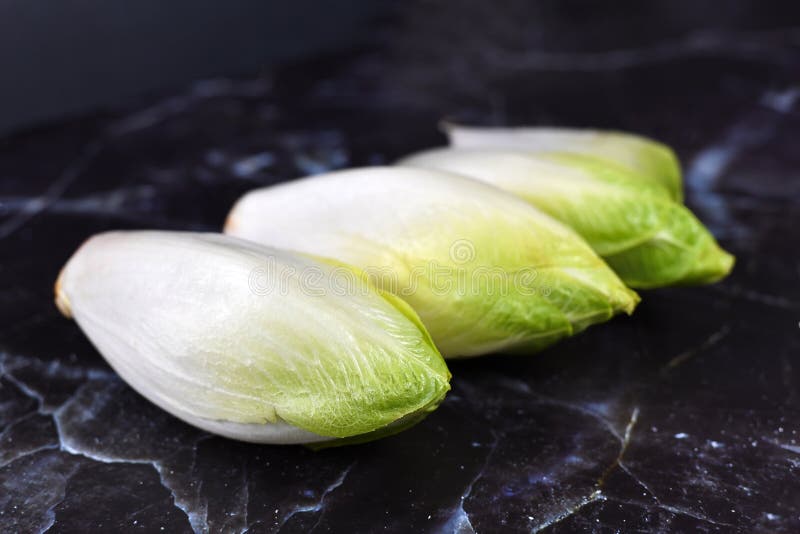 Pieces of Raw Belgian Endive Leaf Vegetables on Dark Background Stock ...