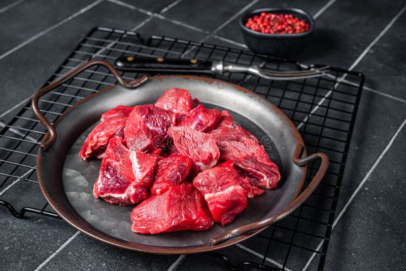 Pieces of Raw Diced Beef Fillet Meat. Black Background Stock Photo ...