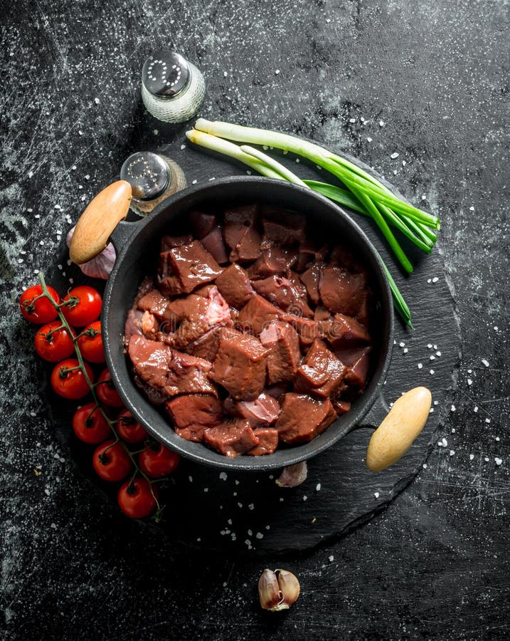 Pieces of Raw Liver in a Pot of Green Onions and Tomatoes Stock Image ...