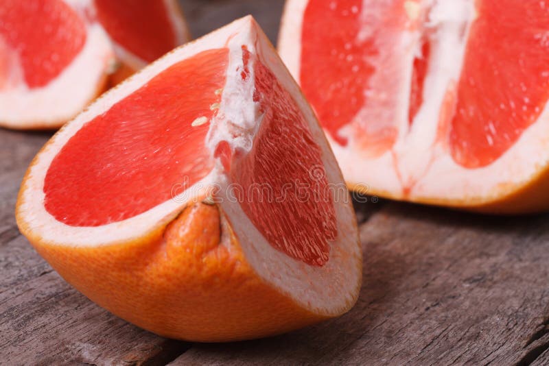Pieces of Red Grapefruit on the Old Wooden Table Closeup Stock Image ...