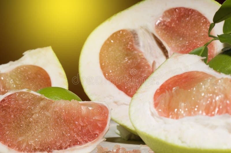 Pieces of Red Pomelo Fruit on an Orange Background Stock Photo - Image ...