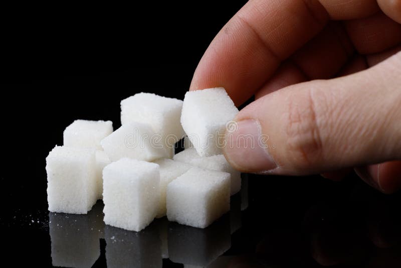 Pieces of Sugar in Hand on a Black Background Stock Photo - Image of ...