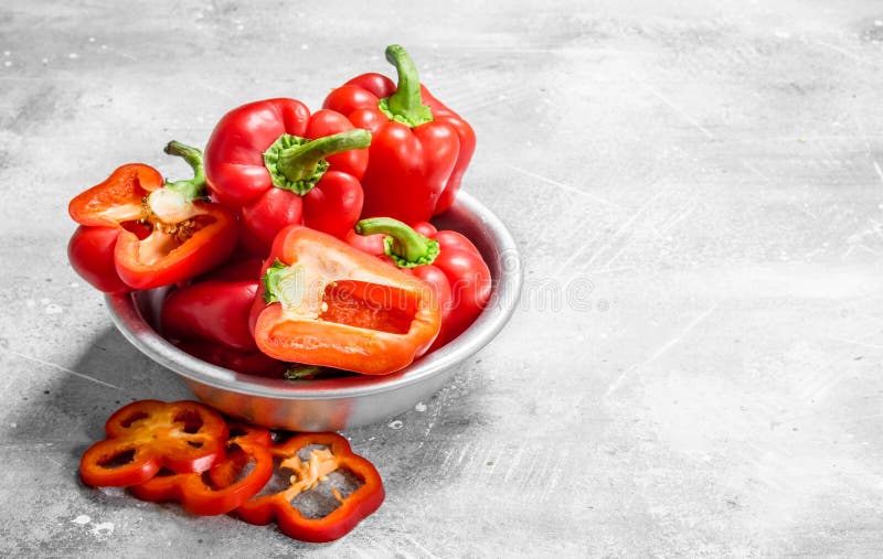 Pieces of Sweet Pepper and Whole Red Peppers in the Bowl Stock Image ...