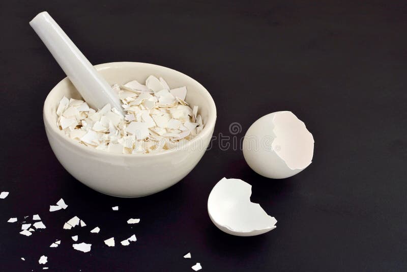 Pieces of White Eggshell in Mortar on Black Background Stock Photo ...