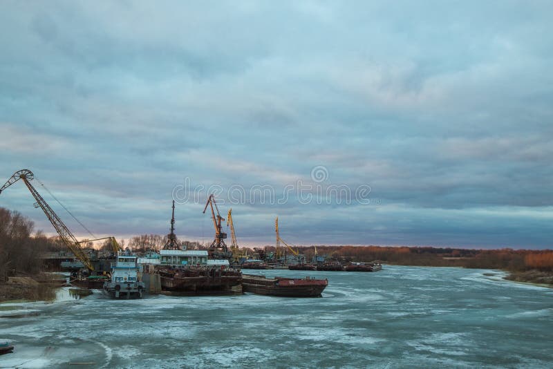 Pier with Cargo Ships on the Frozen River. Stock Photo - Image of ...