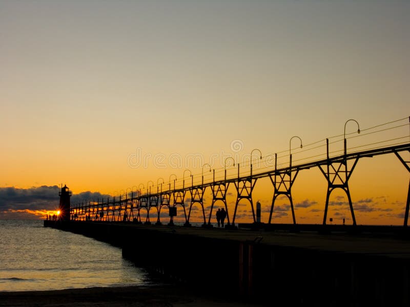 Pier with Catwalk and Lighthouse at Sunset Stock Photo - Image of ...