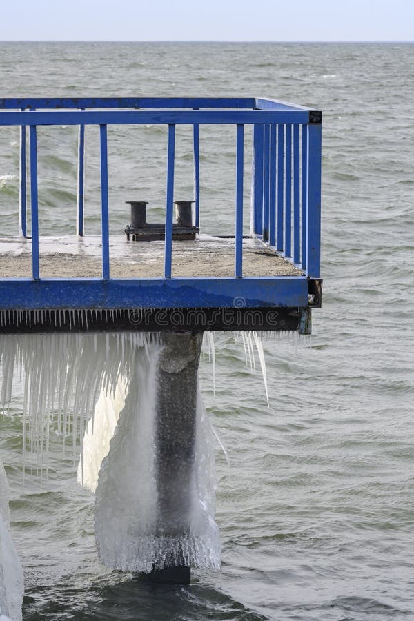 A Pier Covered with Ice in a Still Unfrozen Sea Stock Photo - Image of ...