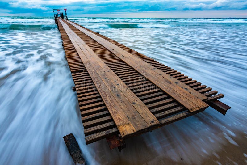 Pier Going To Sea and Sea Surf after Sunset Stock Photo - Image of ...