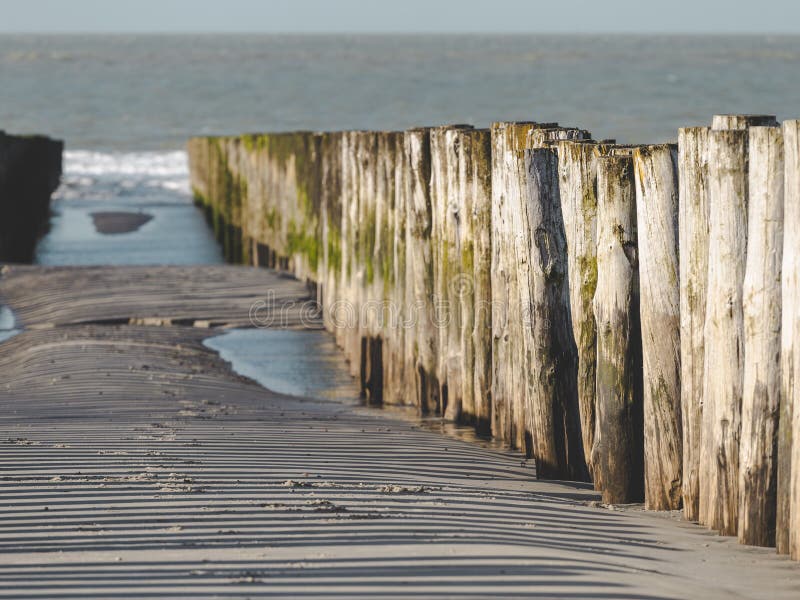 Pier Going into the Water To Keep the Sand on the Beach Stock Image ...