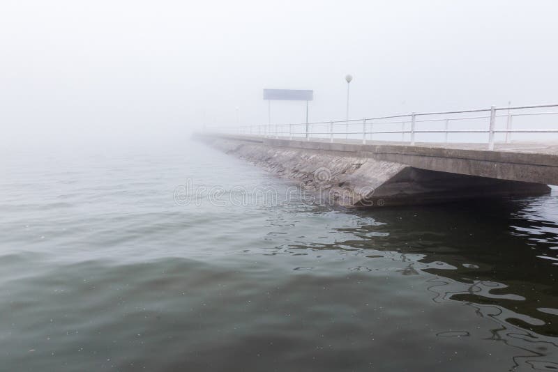 A pier in the midst of fog stock image. Image of calm - 99266389