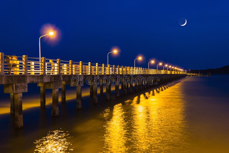 Pier at Night with Yellow Lights on a Background of Blue Sky Stock ...