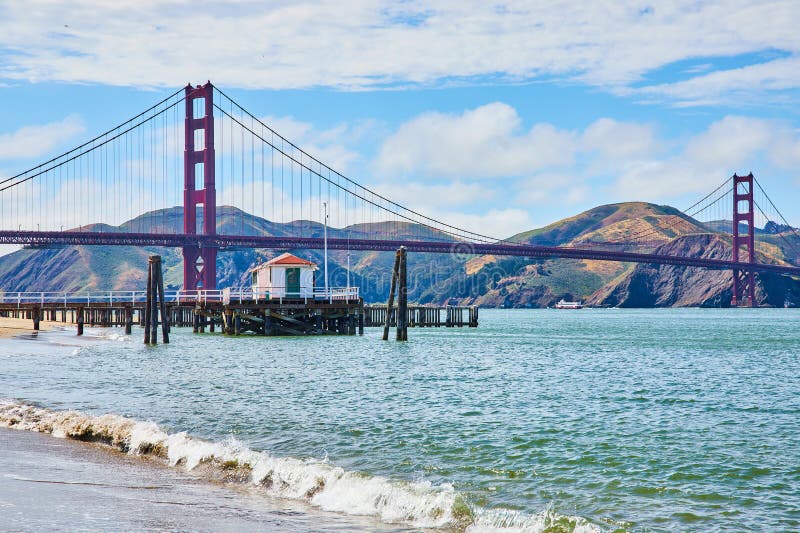 Pier Pole Remnants in Water Framing Small Shack on Dock with Golden ...