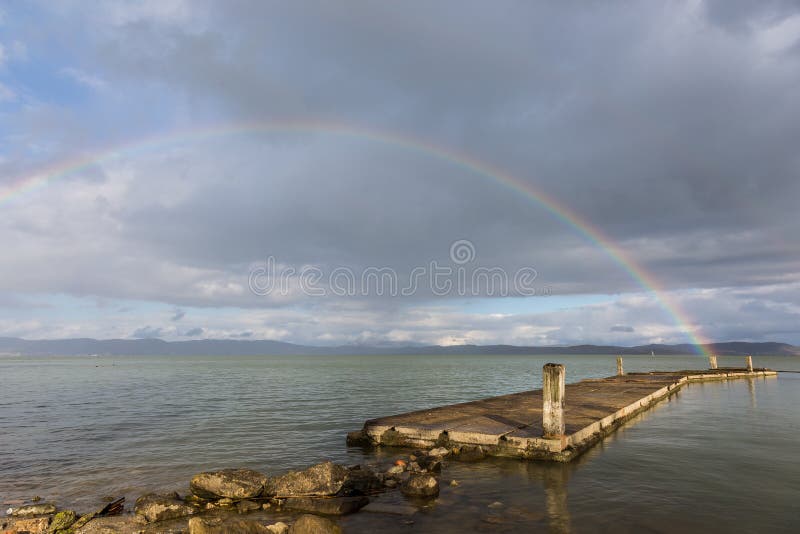Pier and rainbow stock image. Image of light, cloud, blue - 90202781