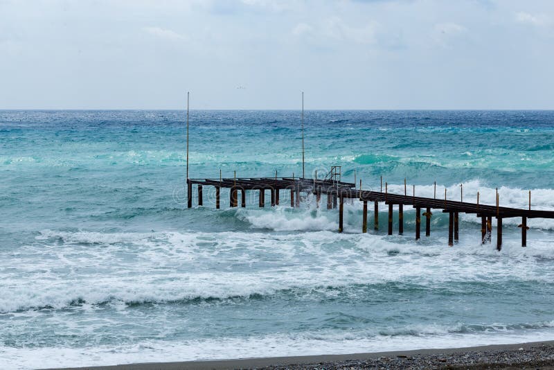 Pier in sea during storm stock image. Image of beach - 91633937
