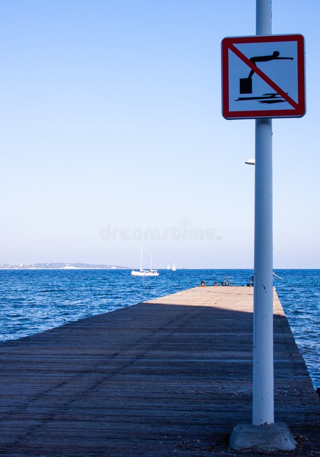 A Pier with a Sign Post for Dive Interdiction Stock Image - Image of ...