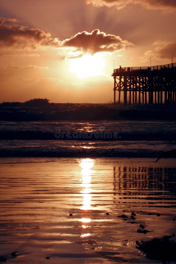Pier at sunset stock image. Image of jetty, water, beach - 10491917