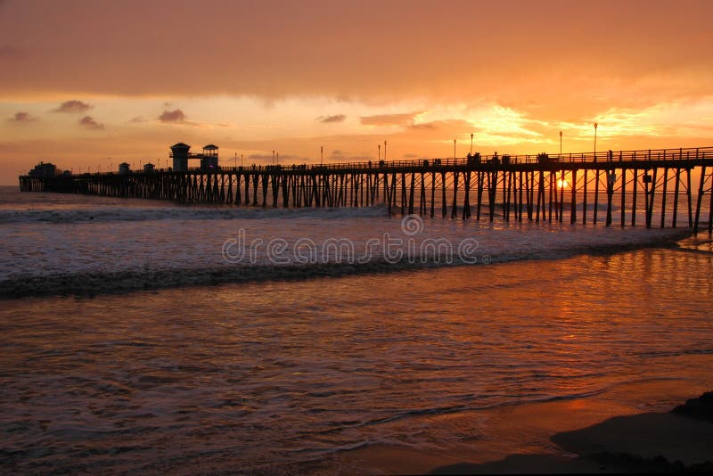 Pier at sunset stock image. Image of pier, wave, orange - 13920465