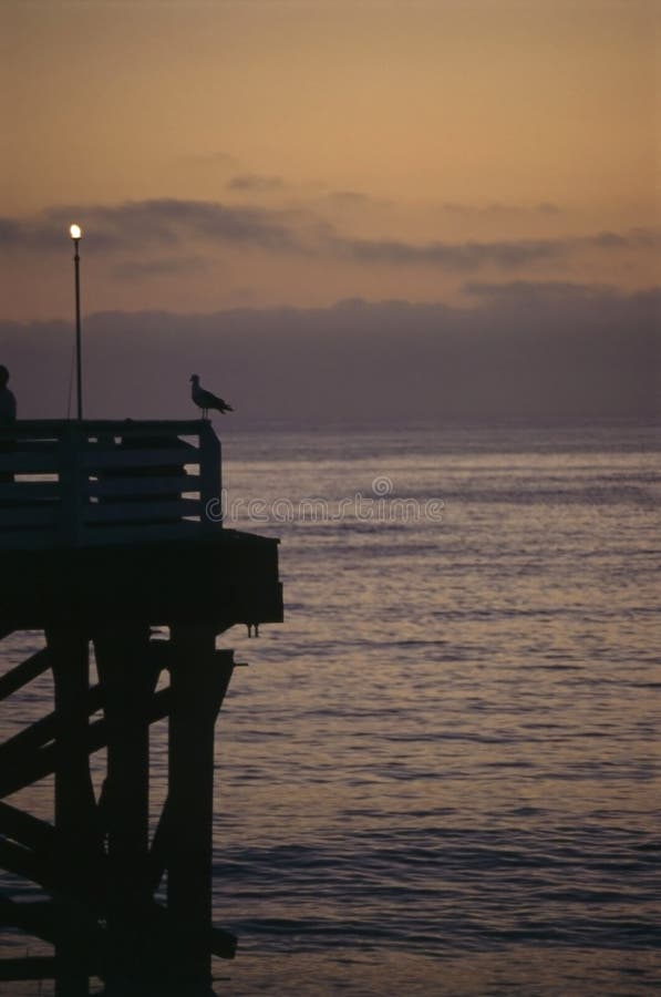 Pier at sunset stock photo. Image of ocean, sunset, people - 15318458