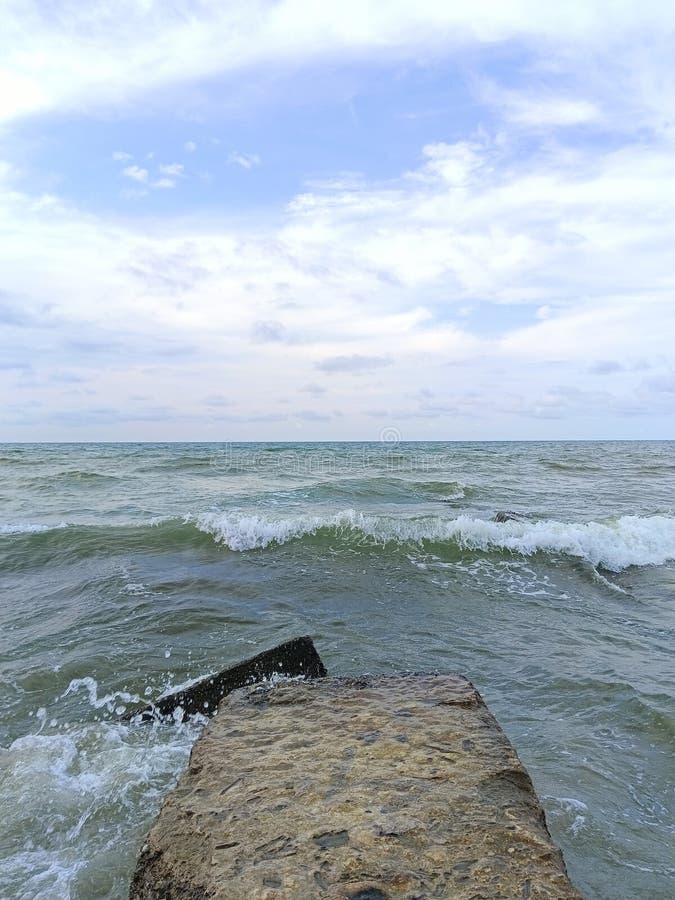 Pier with waves in front stock photo. Image of coast - 299011954
