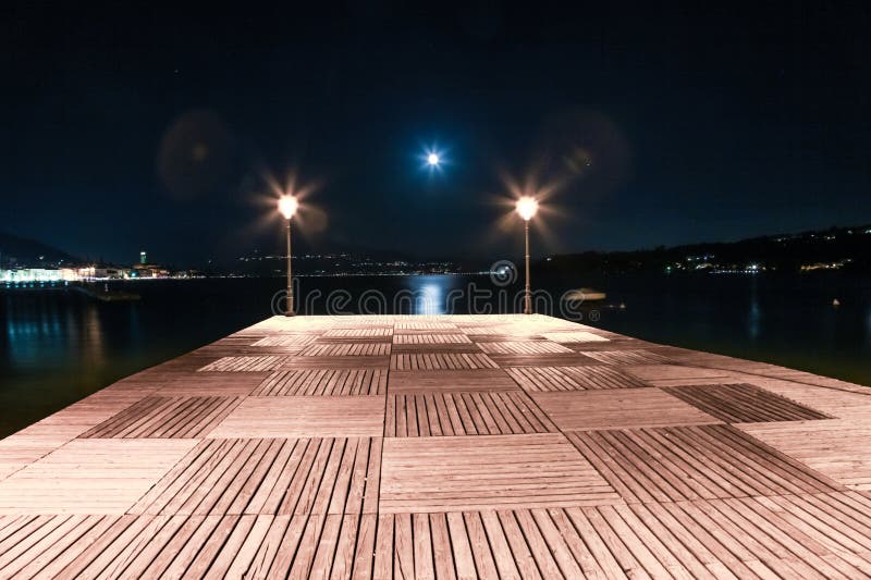 A Pier with a Wooden Floor and a Large Moon in the Sky Stock Photo ...