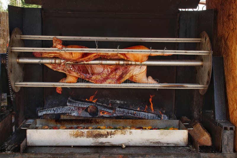 Pig roasted on a spit stock image. Image of fire, cooking - 255744101