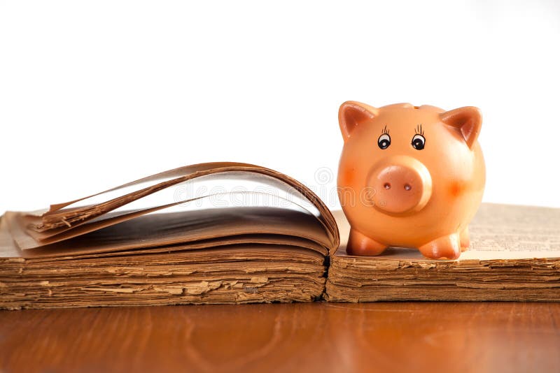 Piggy bank on the old book stock image. Image of reading - 31423135