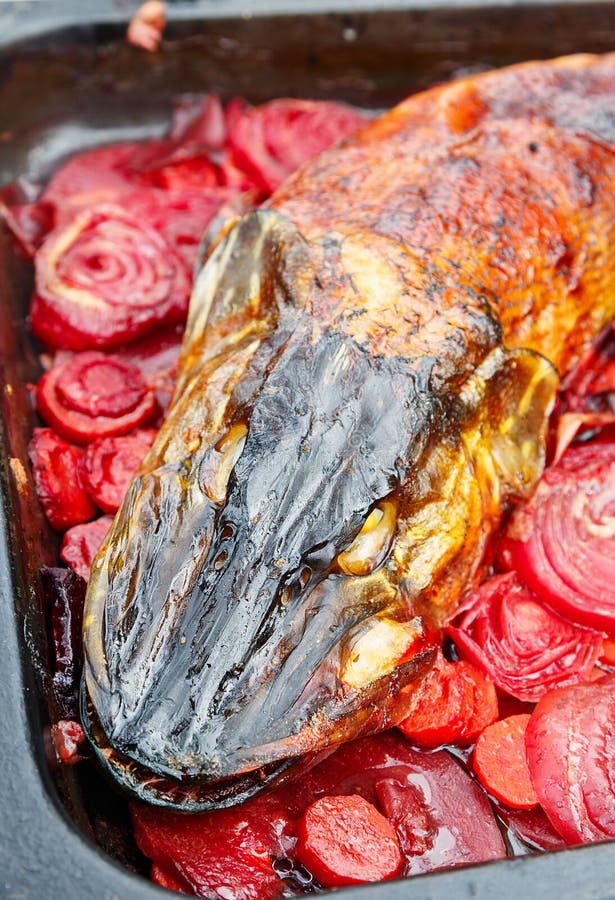 Pike baked with vegetables stock photo. Image of head - 63175678