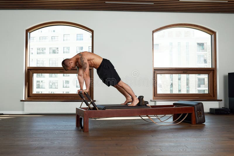 Pilates Reformer Workout Exercises Man at Gym Indoor. Stock Image ...