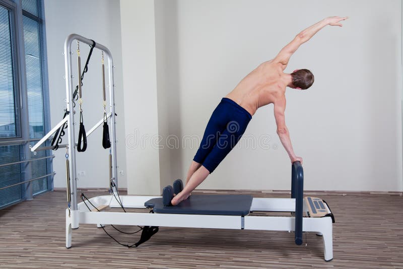 Pilates Reformer Workout Exercises Man at Gym Stock Image - Image of ...