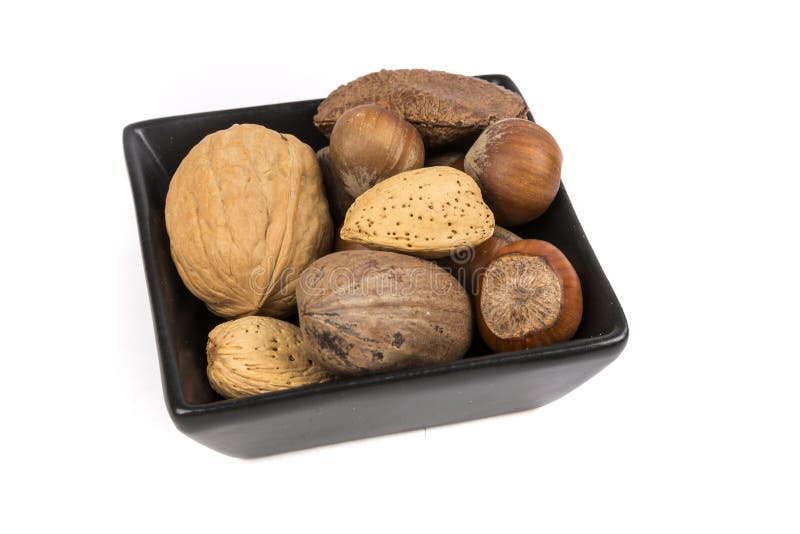Pile of Assorted Nuts in the Shell in a Black Bowl Isolated Over White ...
