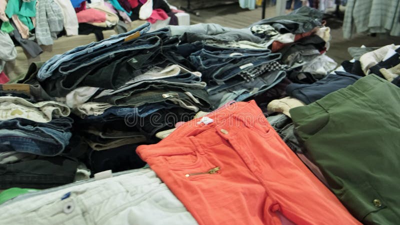 Pile of Assorted Secondhand Pants and Clothing in Thrift Store Display ...