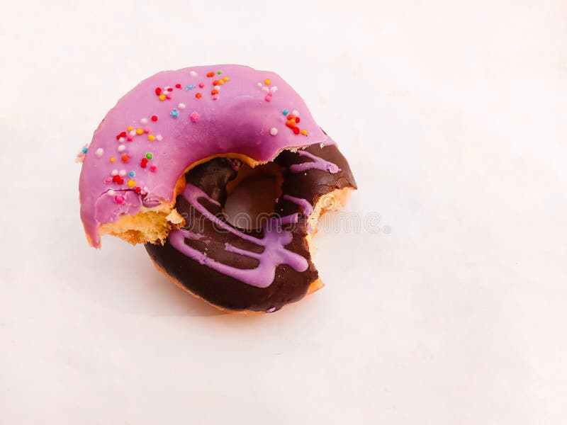 Pile of Bitten Chocolate Donut and Half of a Purple Donut Isolate on White Background. Sweet ...