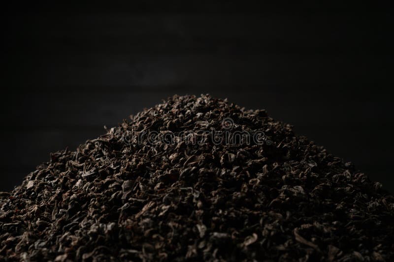 A Pile of Black Fanning or Broken Loose Leaf Tea on a Dark Black ...