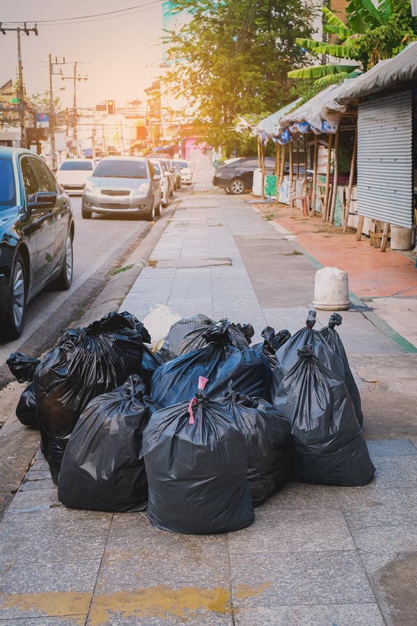 Pile of Black Garbage on the Footpath at Sidewalk Stock Photo - Image ...