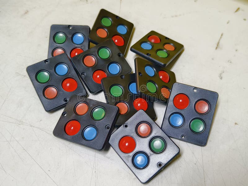 Pile of Black Handheld Devices with Multiple Colorful Push Buttons and ...