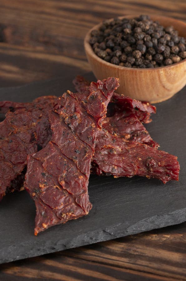 Pile of Black Pepper Beef Jerky on a Rustic Wooden Table Stock Image ...