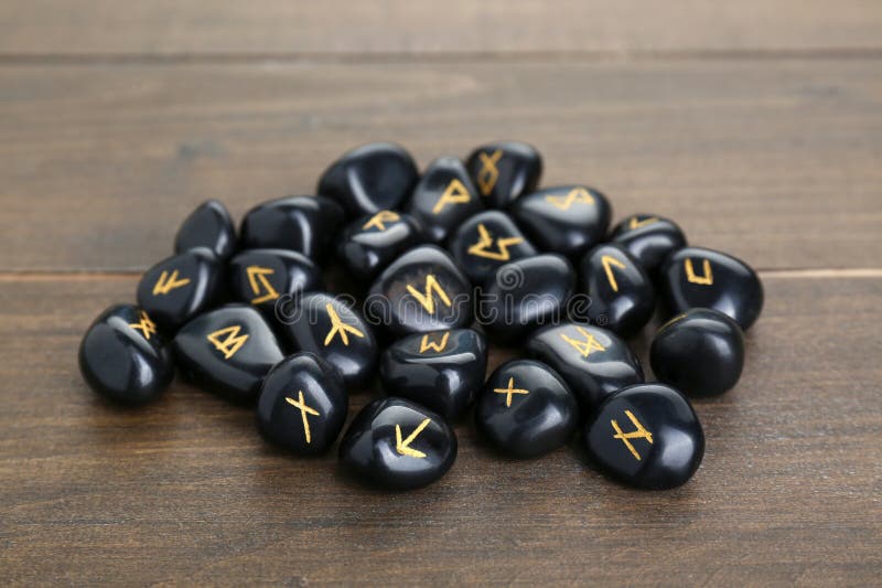 Pile of Black Rune Stones on Wooden Table Stock Image - Image of ...