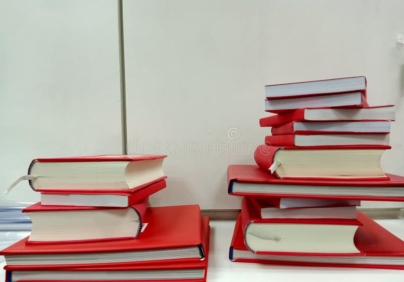A Pile of Books with Many Red Covers on the Table Stock Photo - Image ...