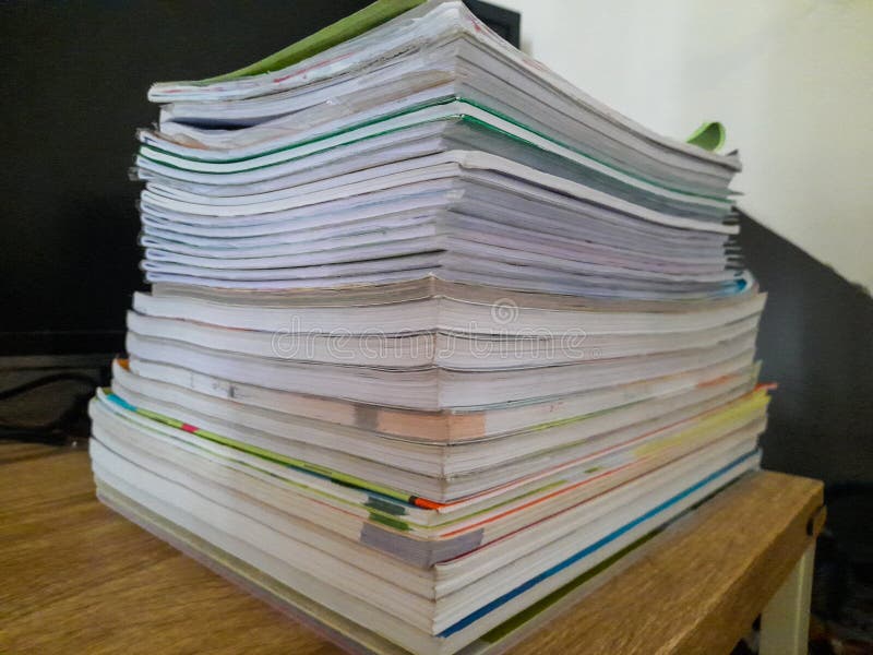 A Pile of Books Neatly Arranged on the Table Stock Image - Image of ...