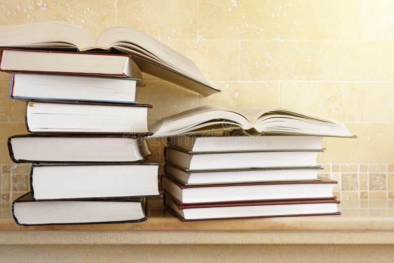 Pile of Books with Open Book on Marble Shelf. Bookshelf with Piled ...