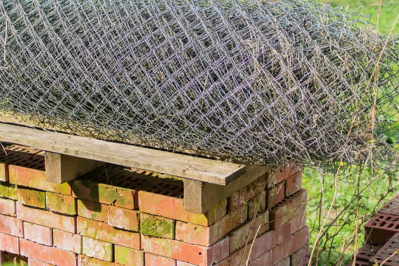 Pile of Bricks and Rolls of Wire Mesh Steel for Construction Outdoors ...