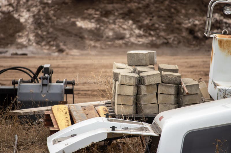 A pile of bricks in a yard stock photo. Image of earthmoving - 368655294