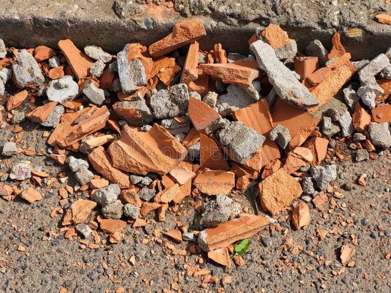 A Pile of Broken Red Bricks is Lying on the Grass Repairing the Wall of ...
