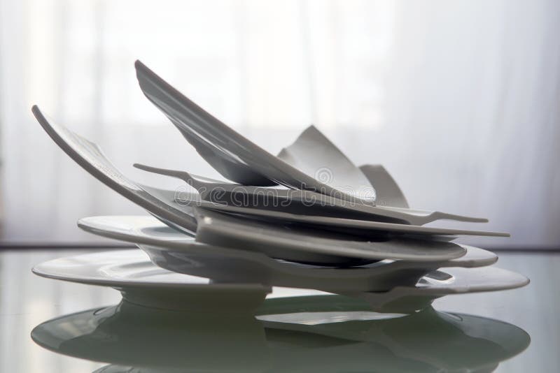 Pile of Broken White Plates on Glass Table Stock Photo - Image of ...
