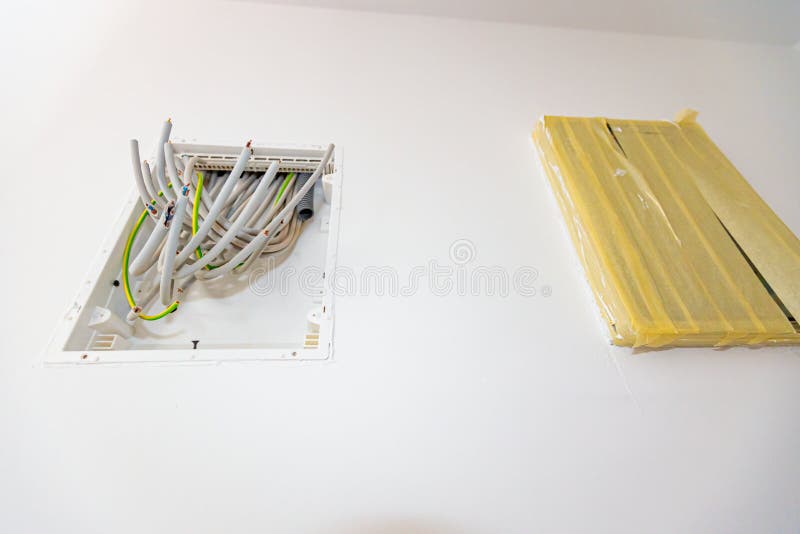 Pile of Cables is Hanging from a Fuse Box Placed on the Wall of ...