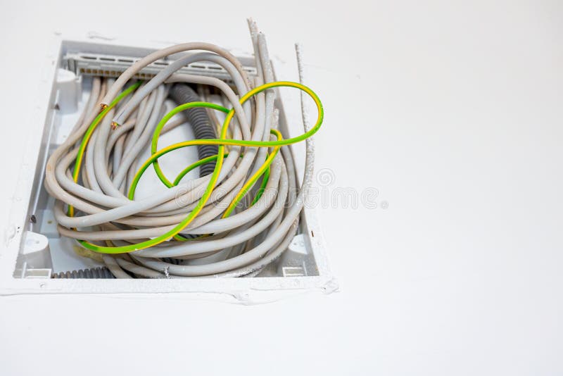 Pile of Cables is Hanging from a Fuse Box Placed on the Wall of ...